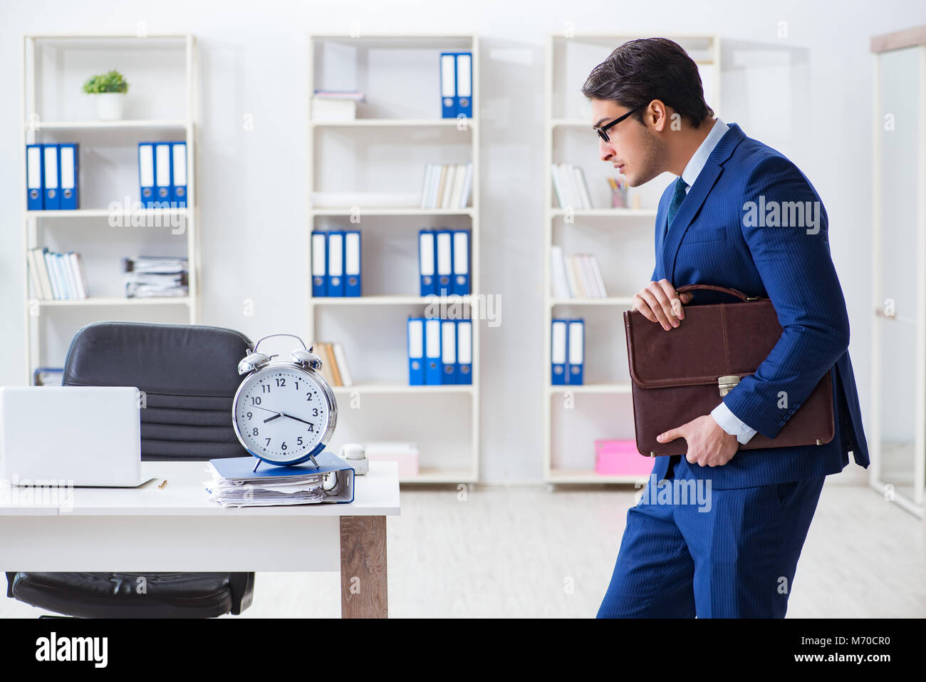 Businessman in bad time management concept Stock Photo - Alamy