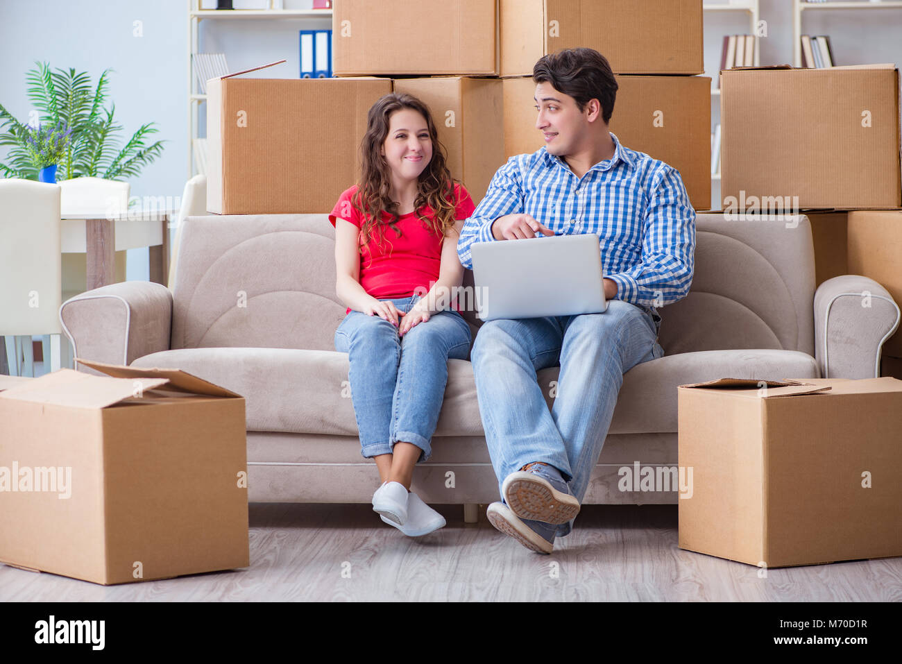 Young pair moving in to new house with boxes Stock Photo - Alamy