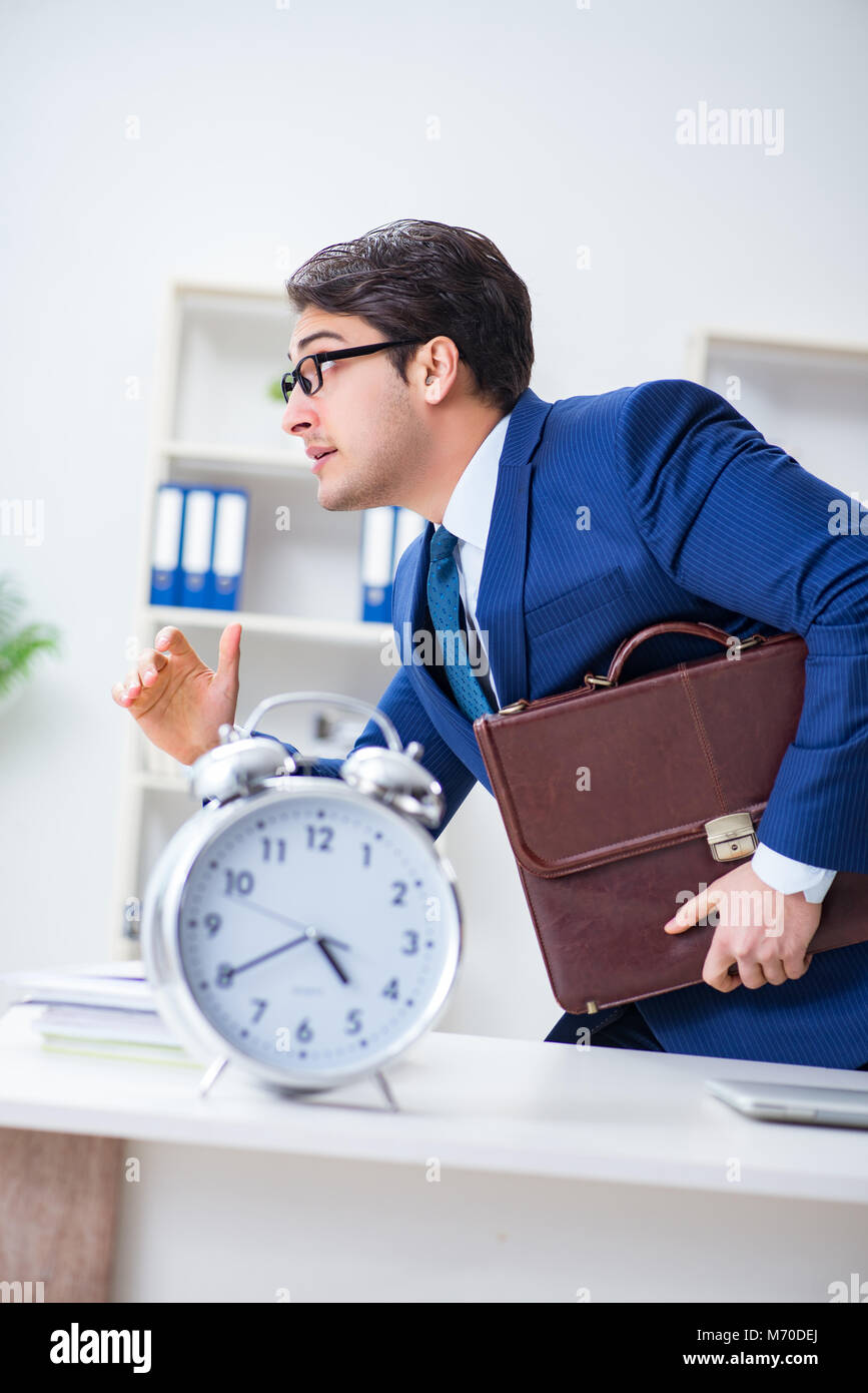 Businessman in bad time management concept Stock Photo - Alamy