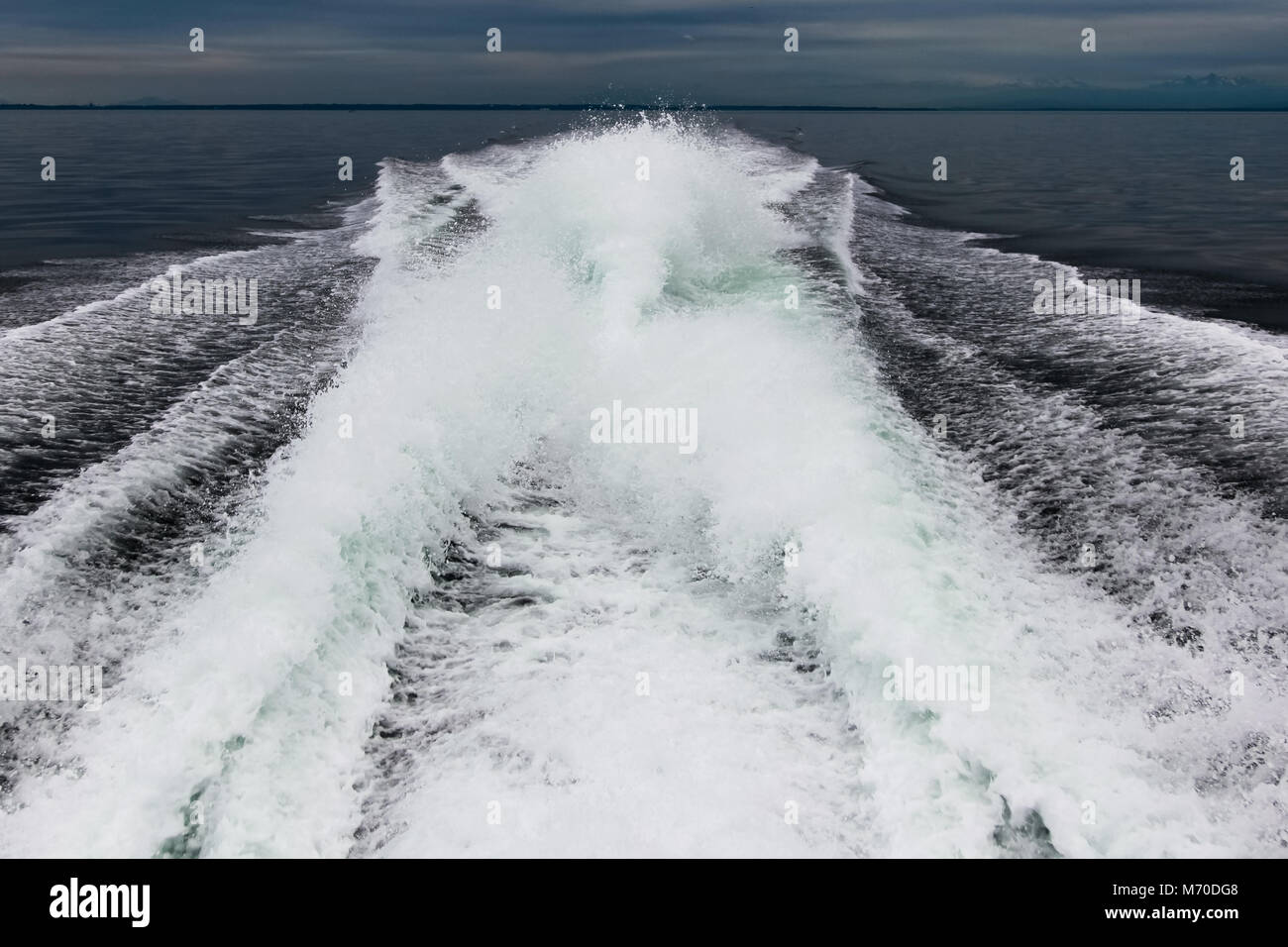 Big bright wake on darker water from a big powerful boat with 4 V8 ...