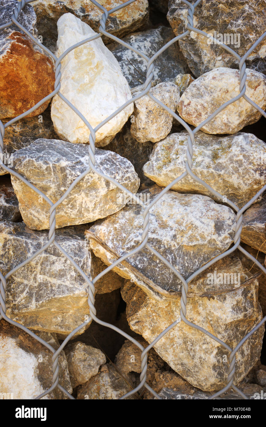 Background of large stones and metallic grid Stock Photo - Alamy