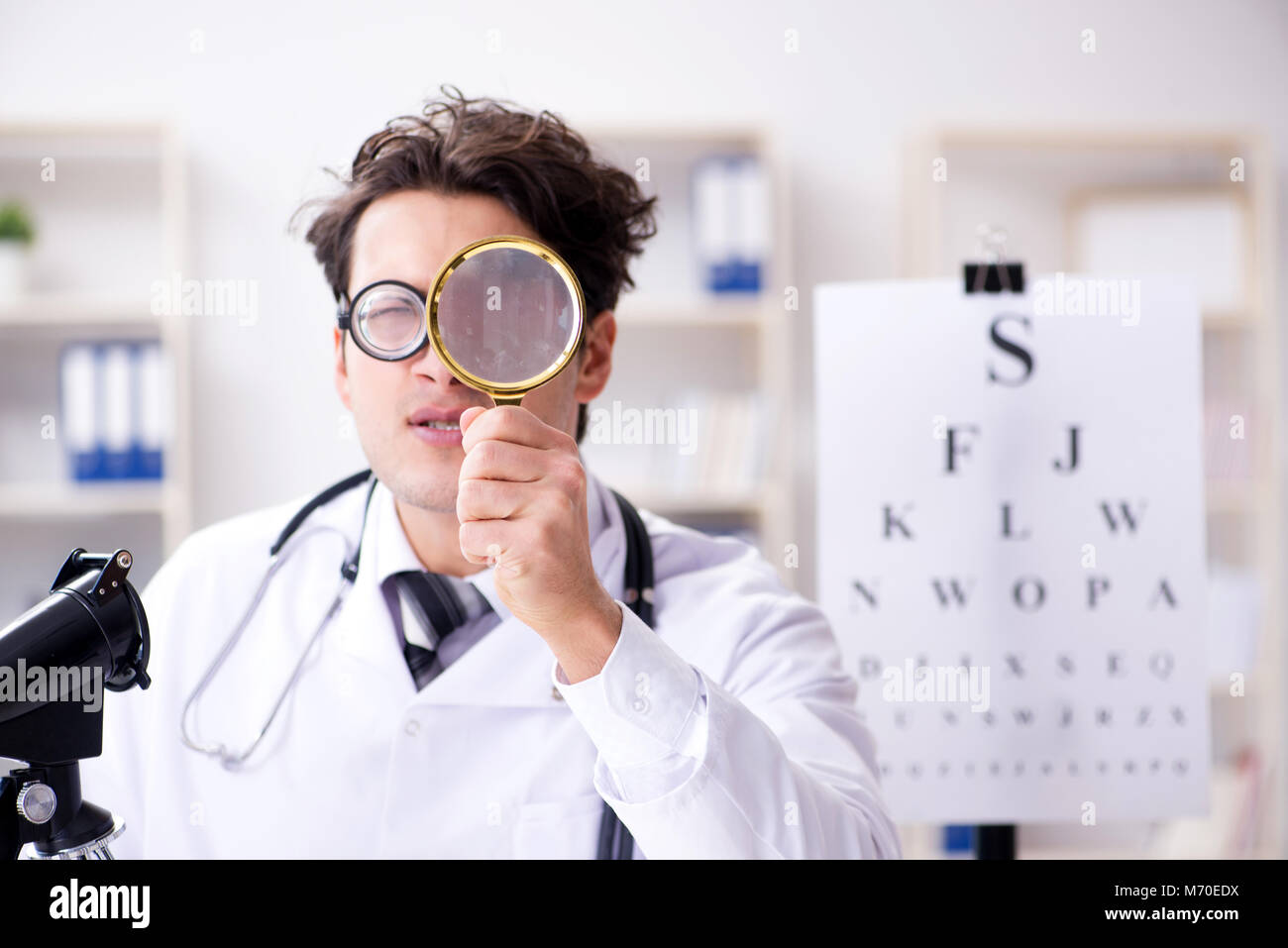 Funny eye doctor in humourous medical concept Stock Photo - Alamy