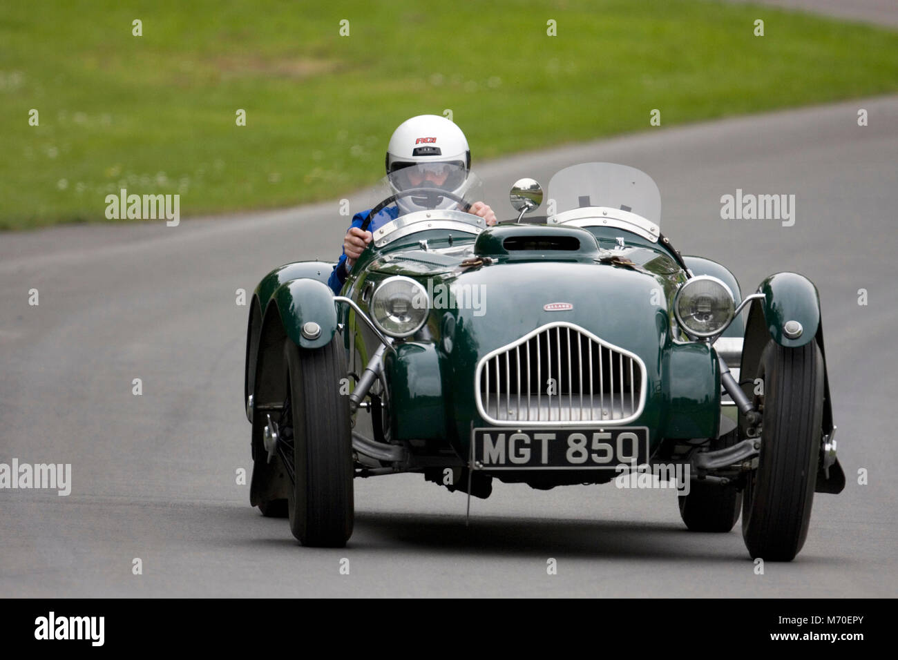 Vintage, British racing green, Allard J2X roadster car driving on the ...