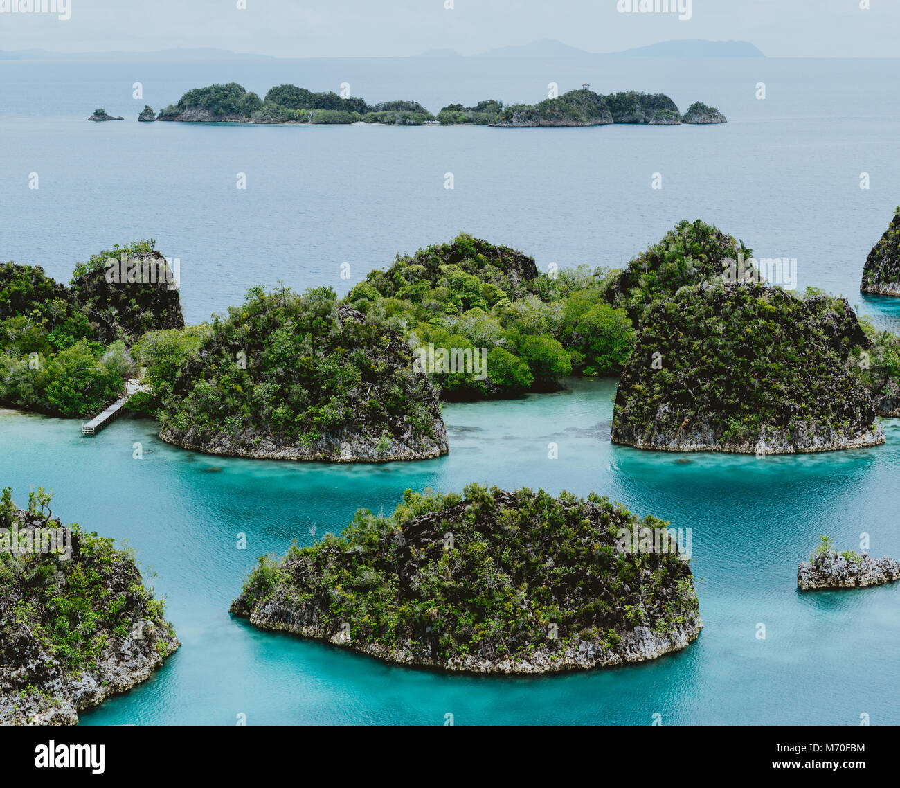 Painemo, Group of small island in shallow blue lagoon water, Raja Ampat ...