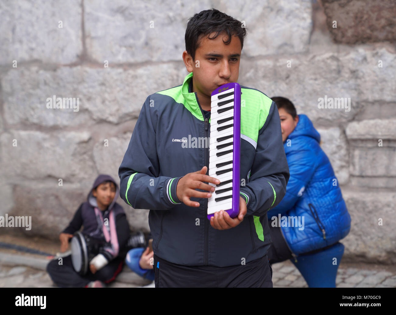 Young musician boys playing instruments around Ankara Castle in Turkey ...