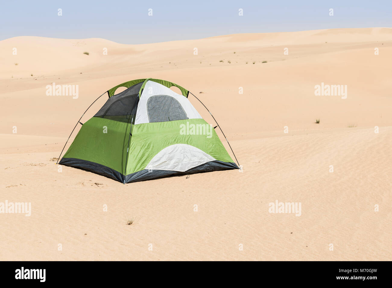 Single tent set against a vast desert backdrop beside, adventure and ...