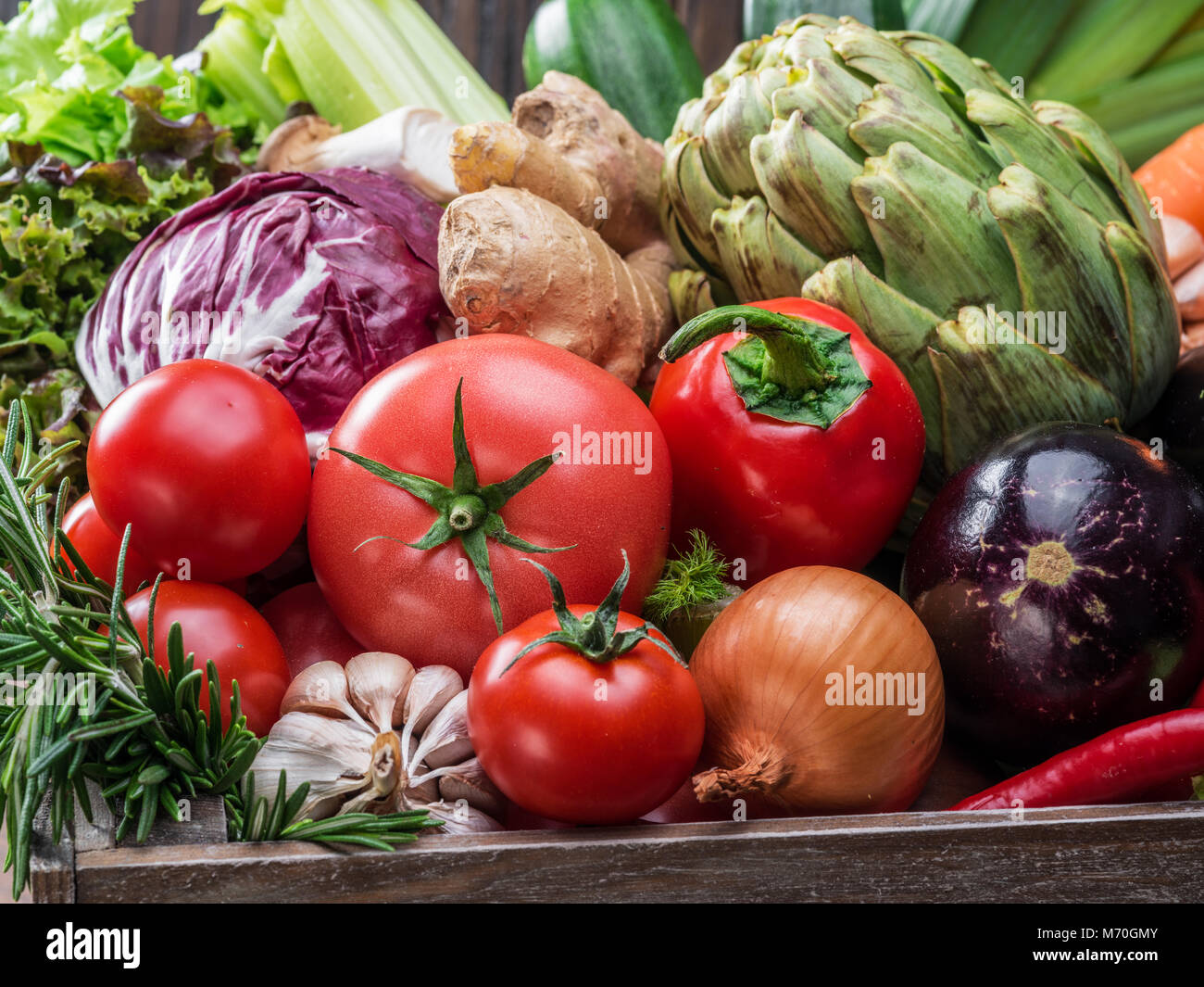 Fresh multi-colored vegetables in wooden crate. Top view Stock Photo ...