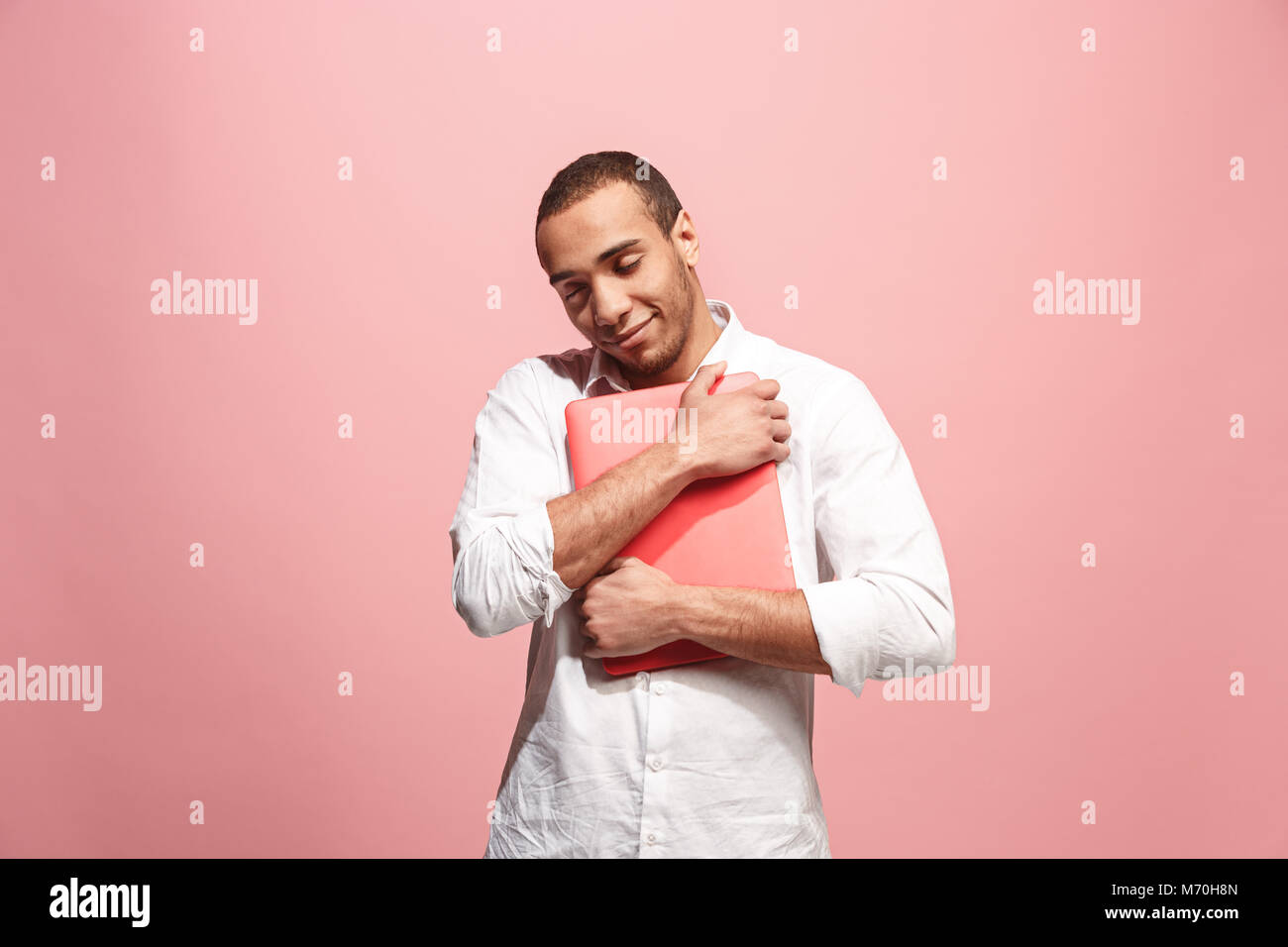 Businessman hugging laptop Stock Photo - Alamy