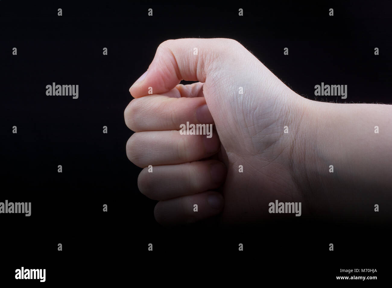 Hand closed for a fist gesture in black Stock Photo - Alamy