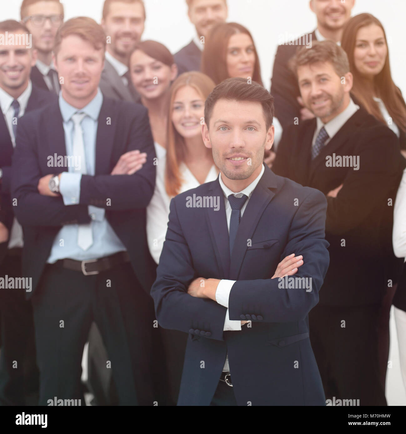 leader standing in front of a large business team Stock Photo - Alamy