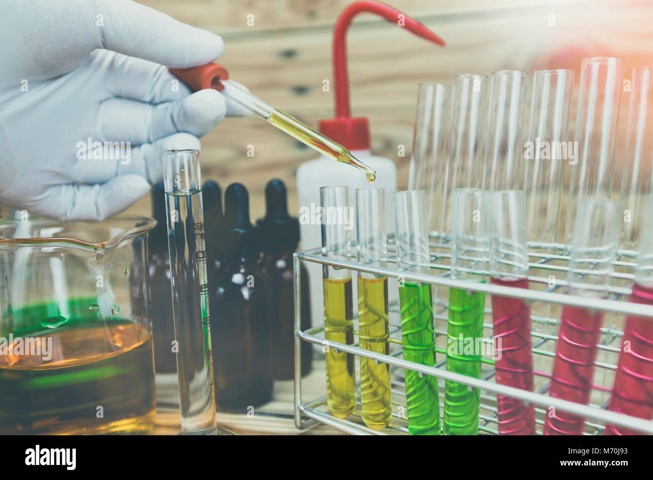 Researcher is dropping the reagent into test tube.Scientist working at ...
