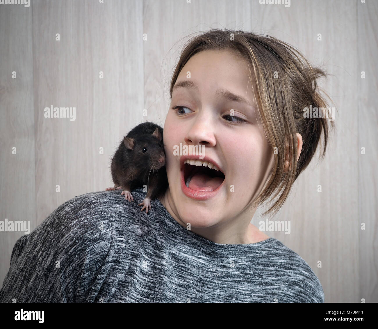 Rat on a girl's shoulder. Emotional portrait-fear, scream, vivid ...
