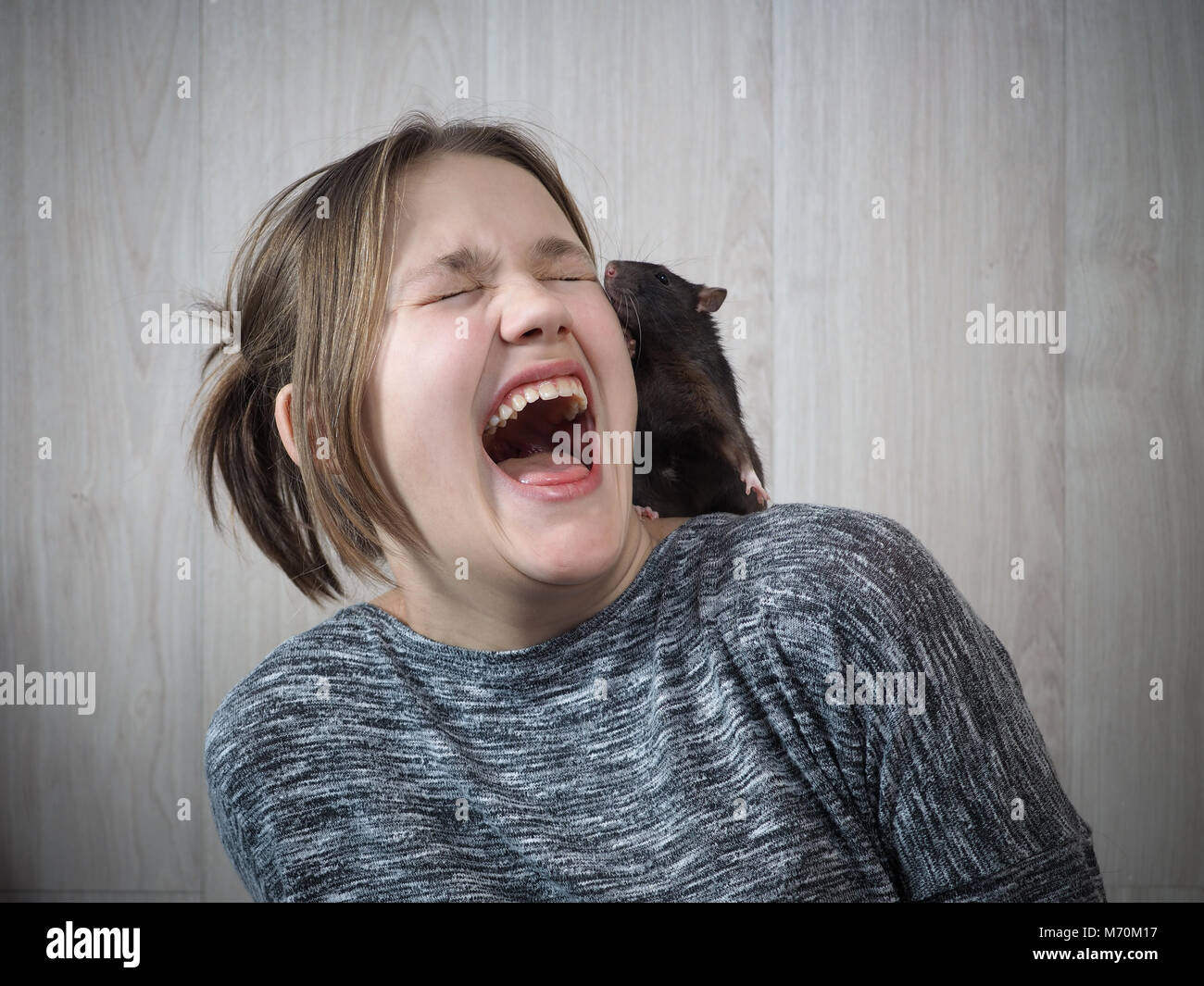 Rat on a girl's shoulder. Emotional portrait-fear, scream, vivid ...