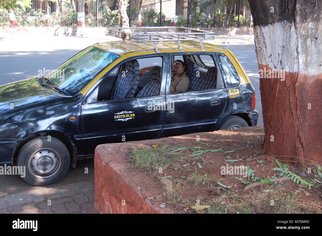 Taxi driver asleep in Mumbai Stock Photo - Alamy