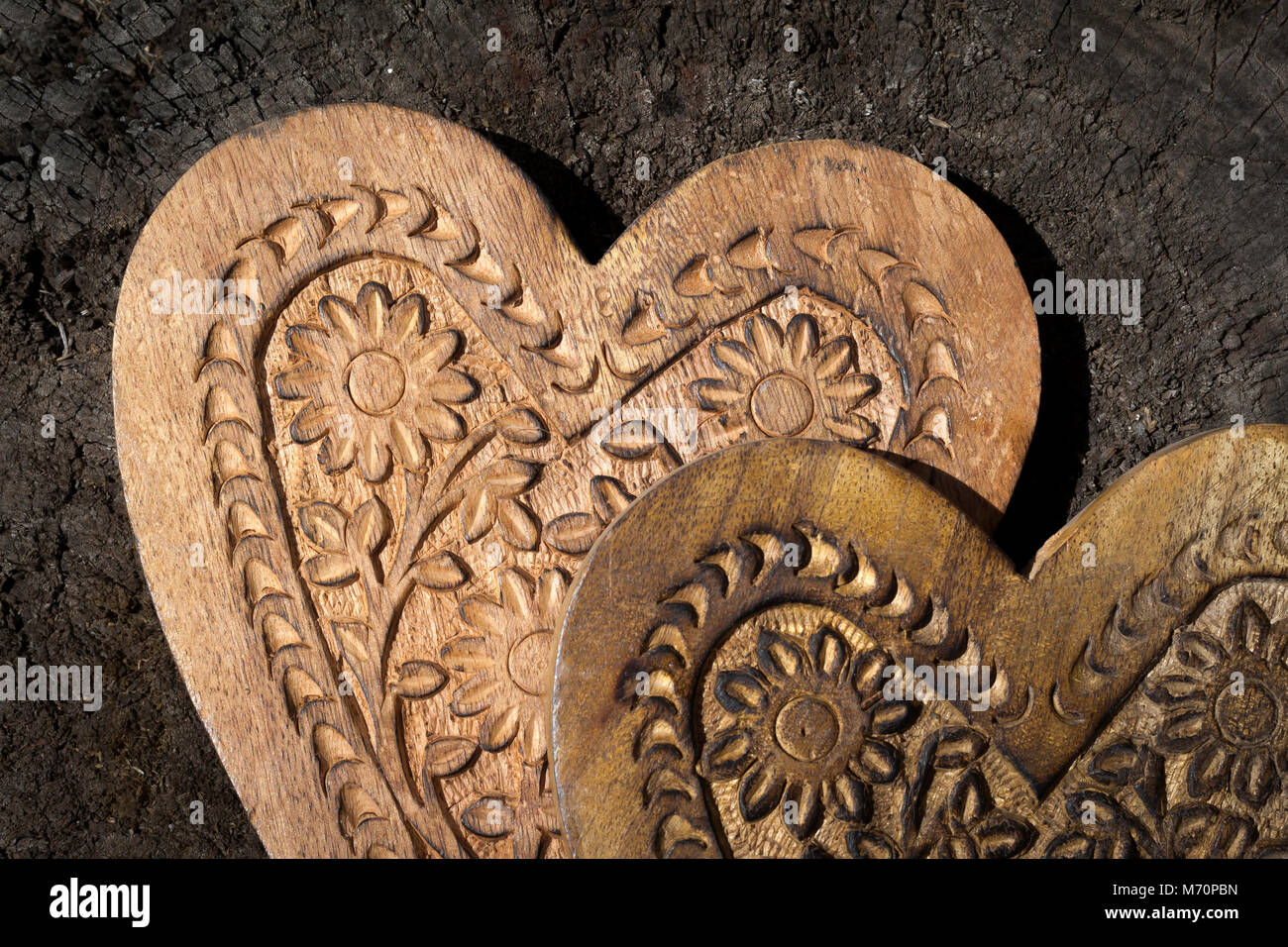Top half of two wooden hearts, one slightly over the other, both hearts ...
