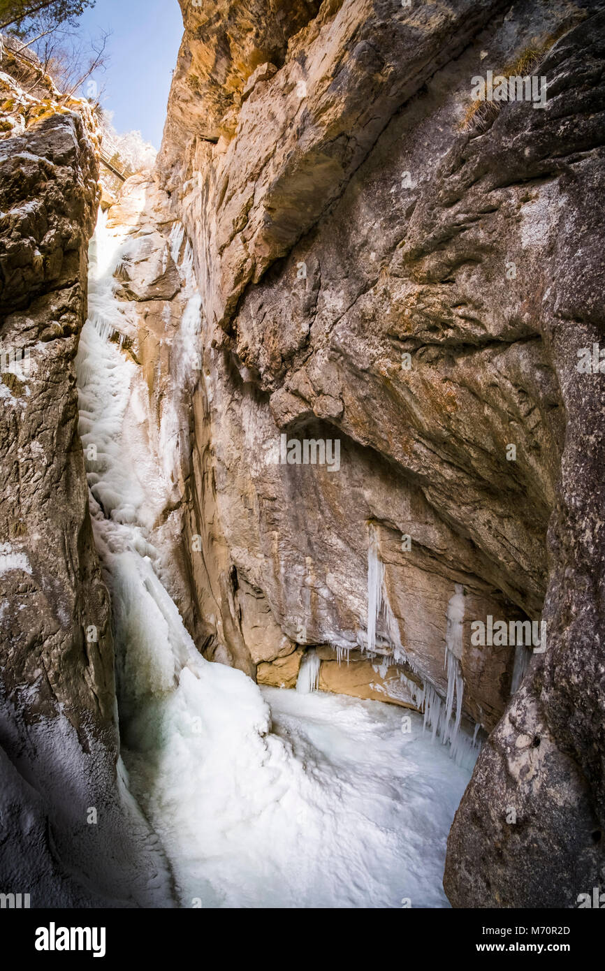 The big frozen icy snow covered waterfall in gorge Baerenschuetzklamm ...