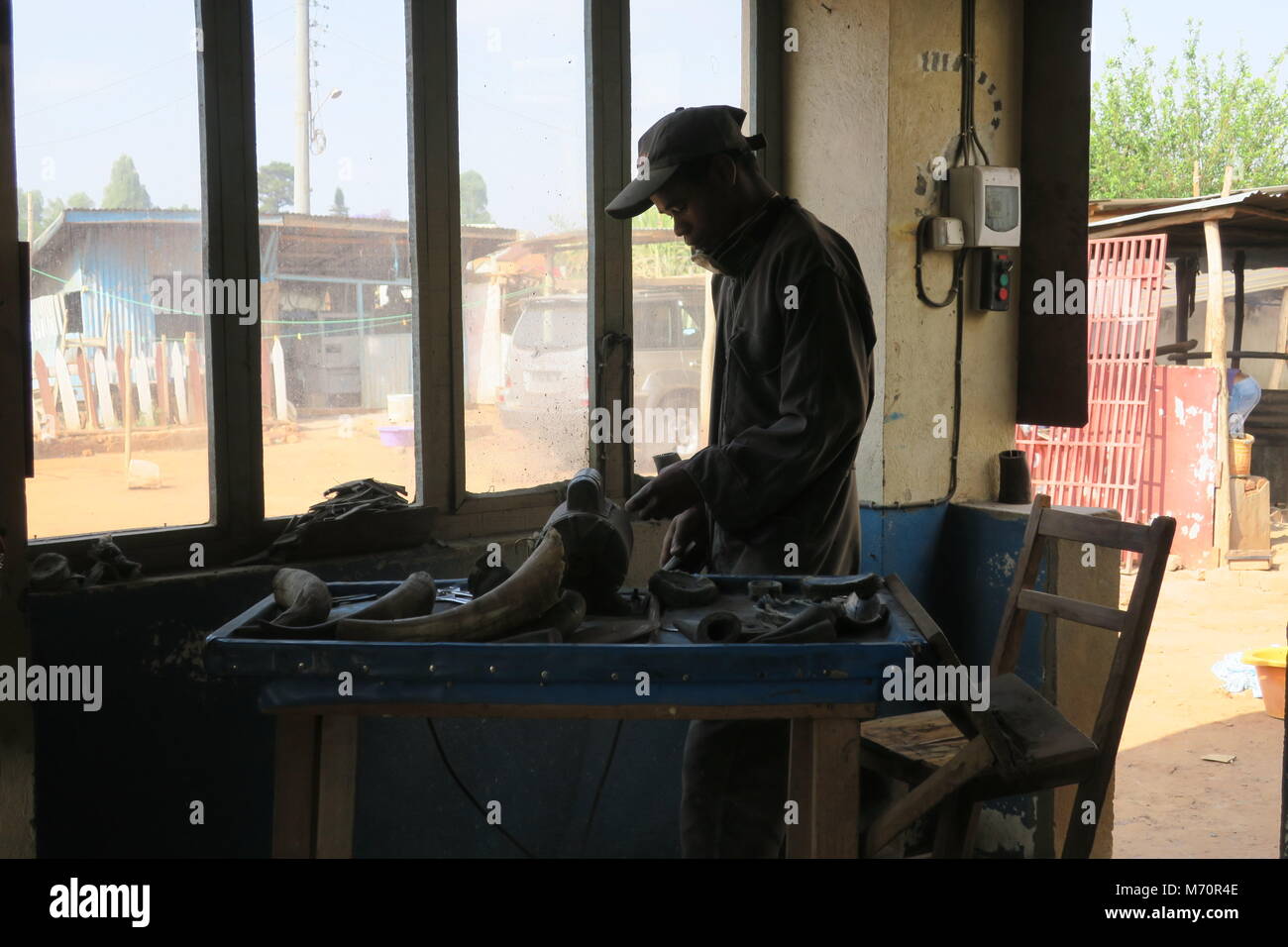 Artisan at work in zebu horn craft workshop, Antsirabe, At horn factory ...