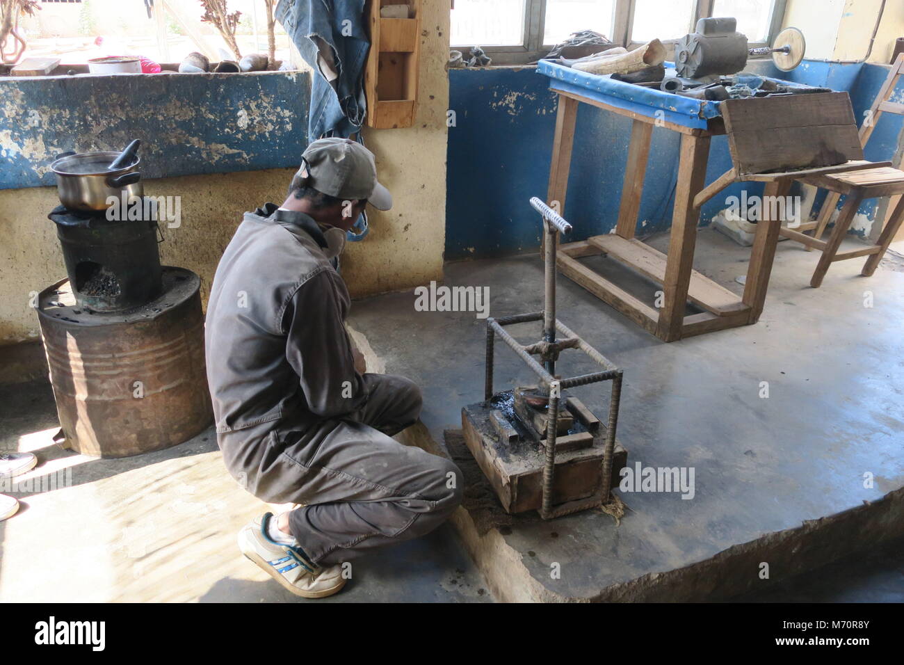 Artisan at work in zebu horn craft workshop, Antsirabe, At horn factory ...