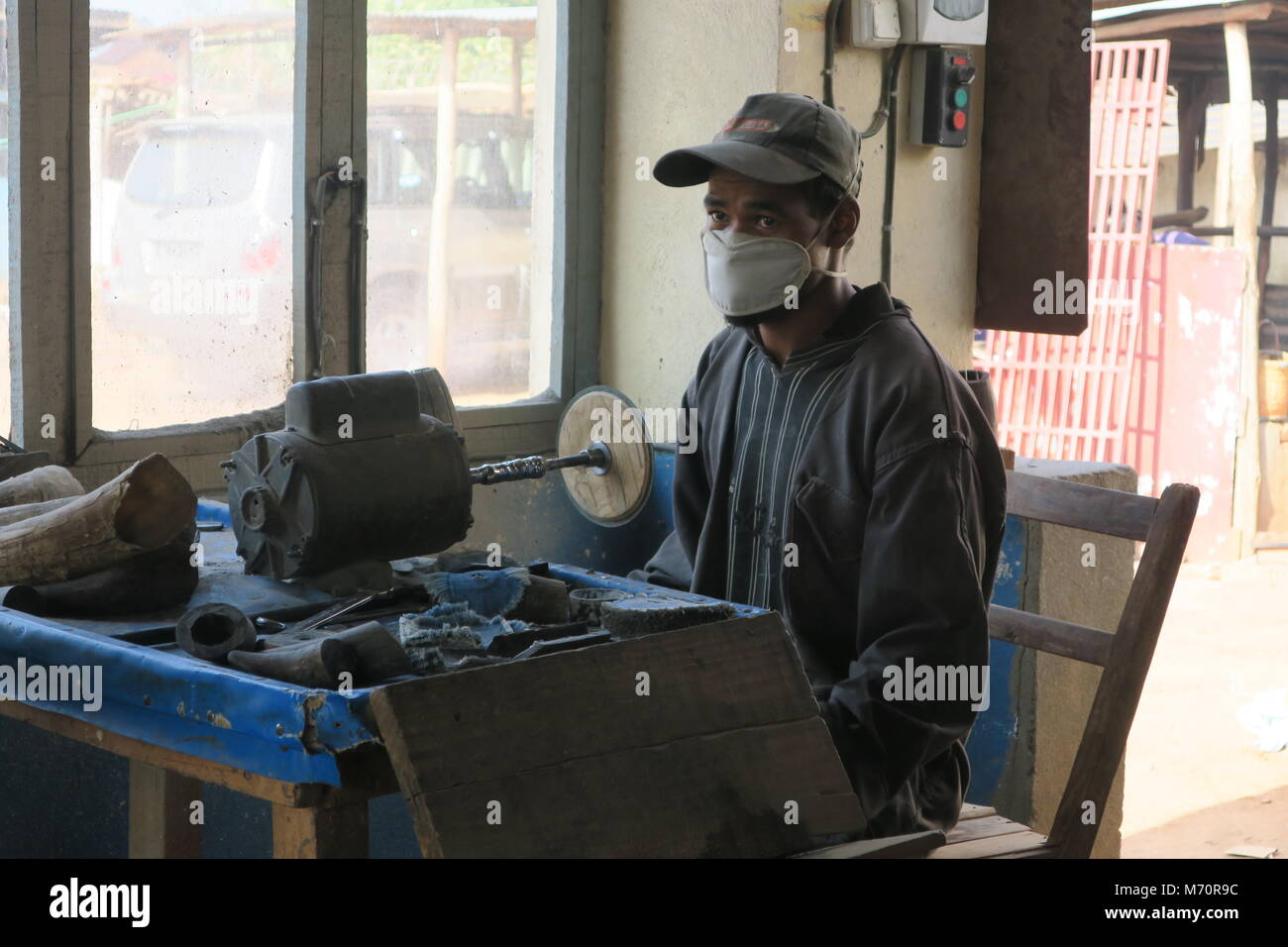 Artisan at work in zebu horn craft workshop, Antsirabe, At horn factory ...