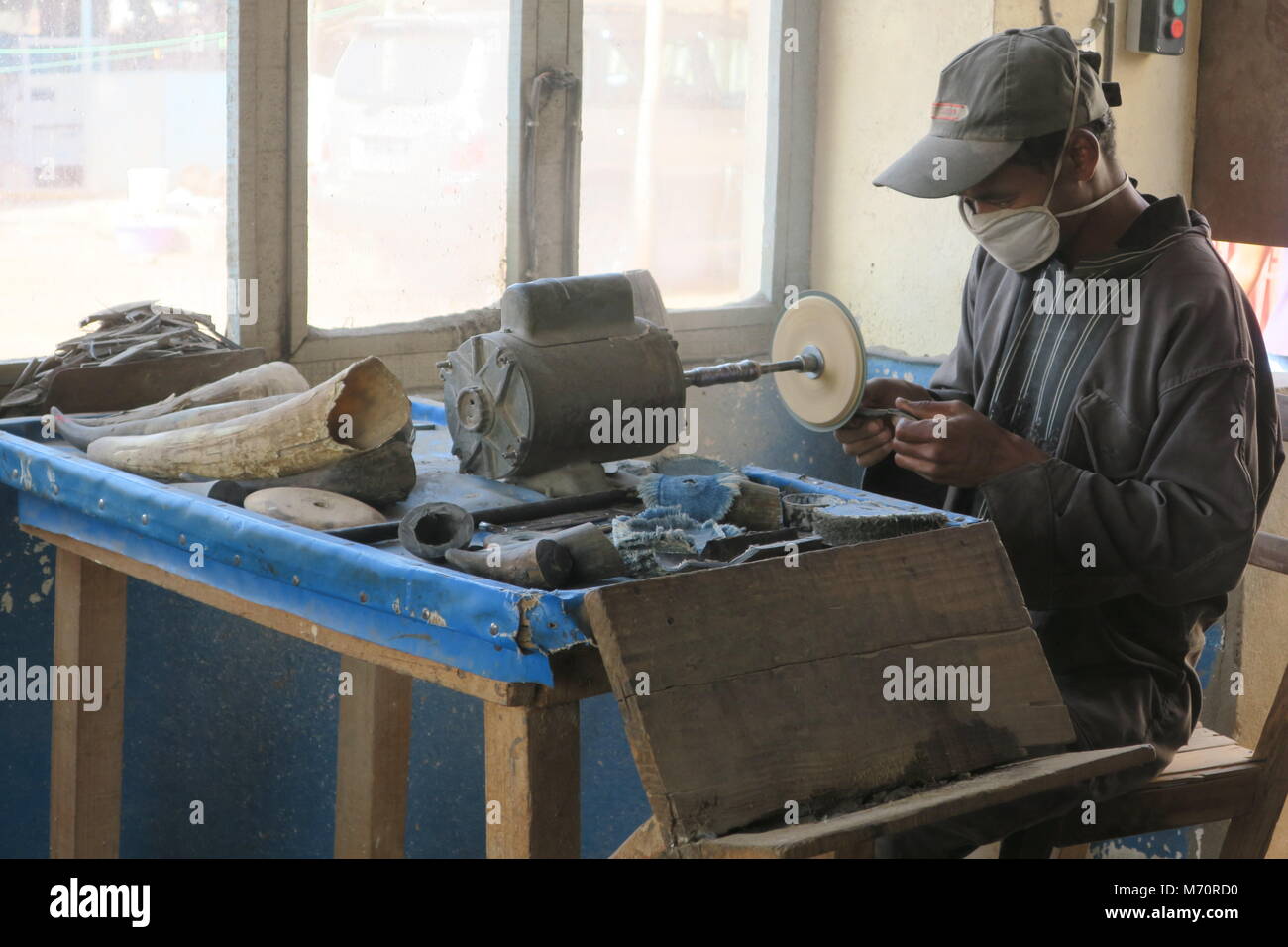 Artisan at work in zebu horn craft workshop, Antsirabe, At horn factory ...