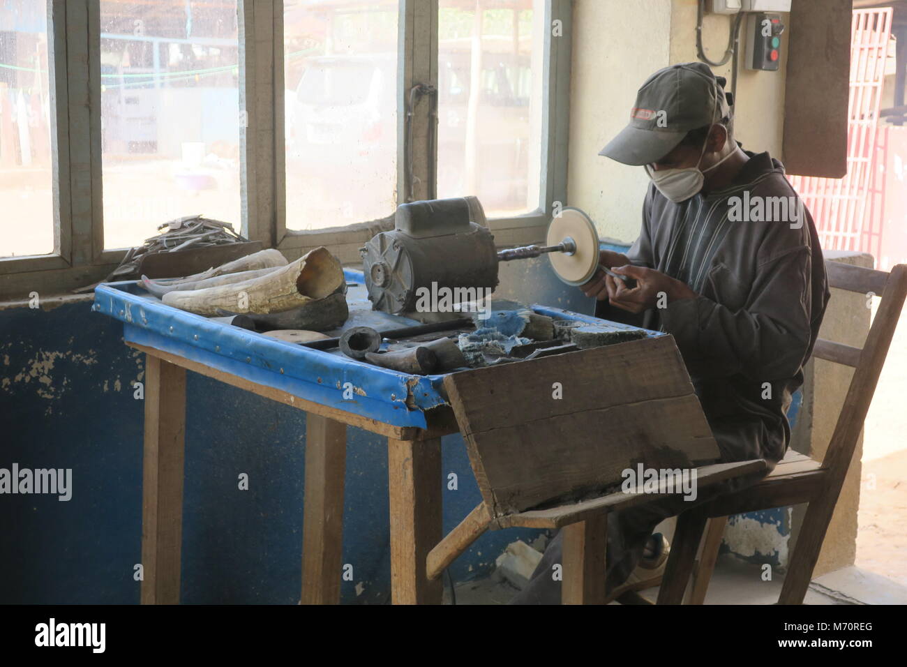 Artisan at work in zebu horn craft workshop, Antsirabe, At horn factory ...