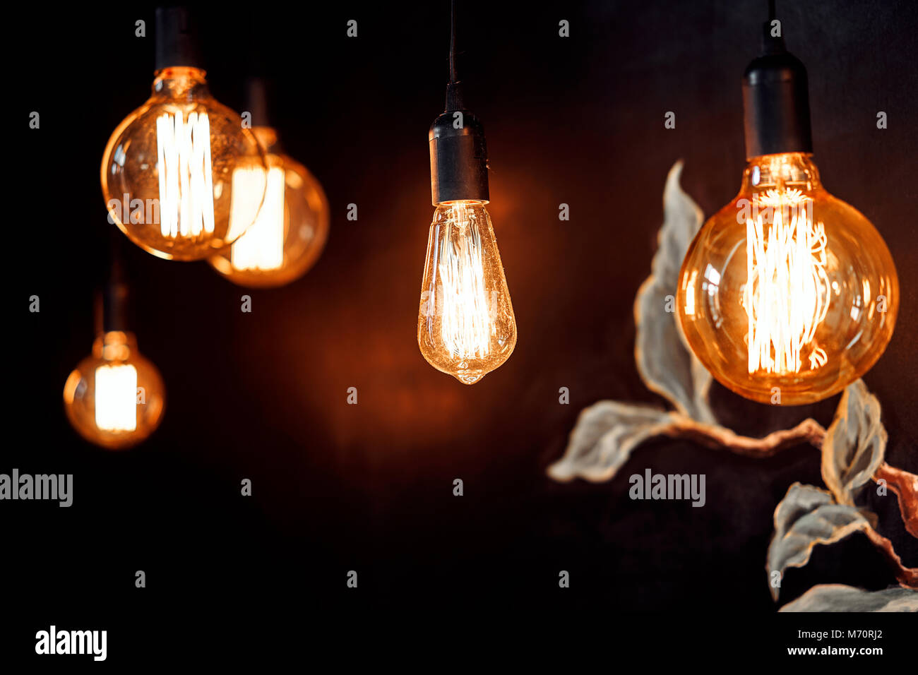 incandescent bulbs on a black background Stock Photo - Alamy