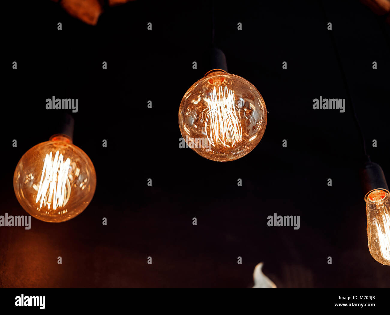 incandescent bulbs on a black background Stock Photo - Alamy