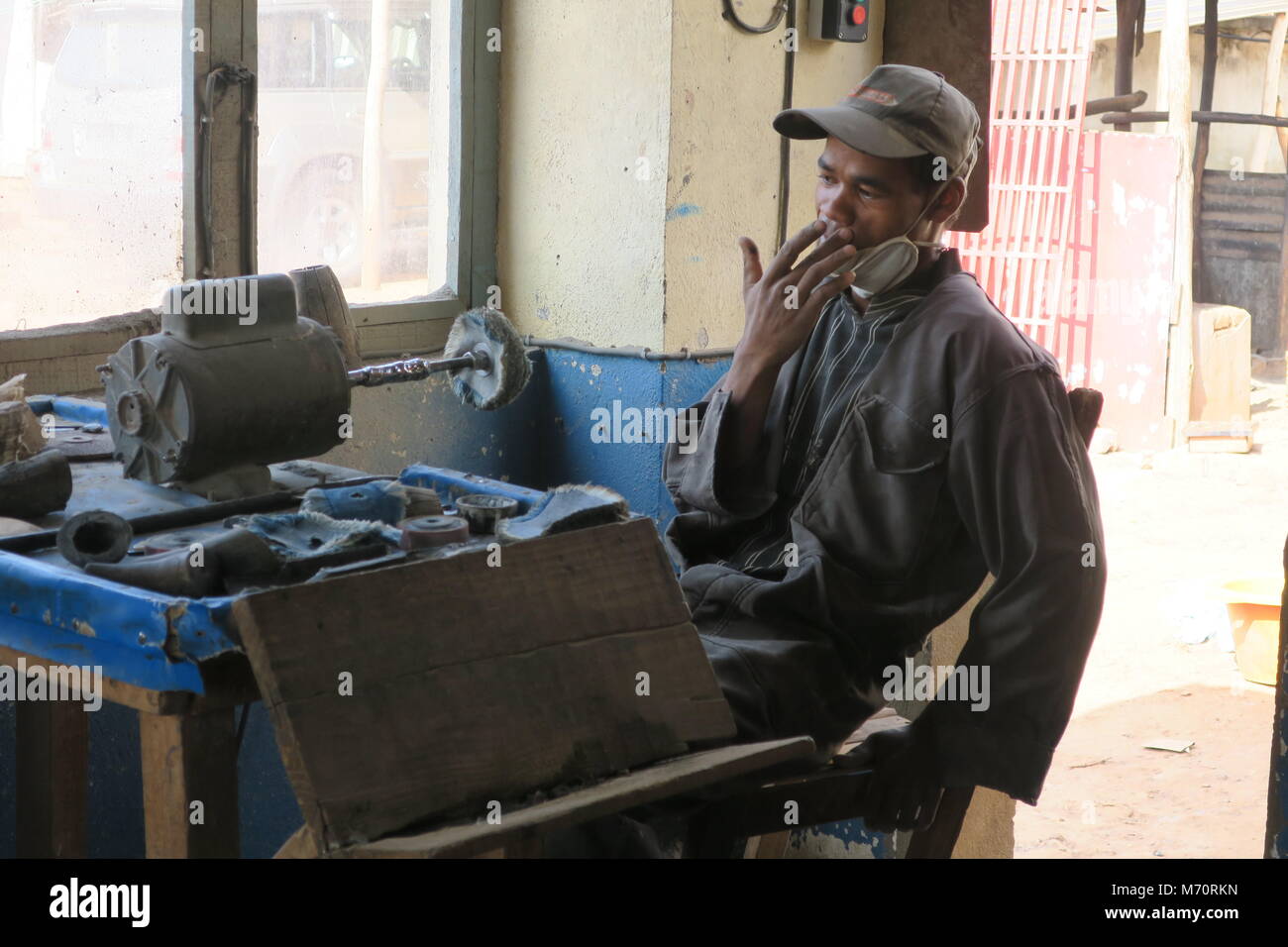 Artisan at work in zebu horn craft workshop, Antsirabe, At horn factory ...