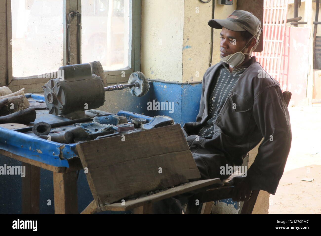 Artisan at work in zebu horn craft workshop, Antsirabe, At horn factory ...