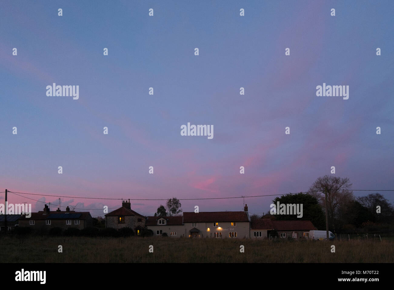 The Wiveton Bell pub at dusk in Wiveton, North Norfolk, UK Stock Photo ...