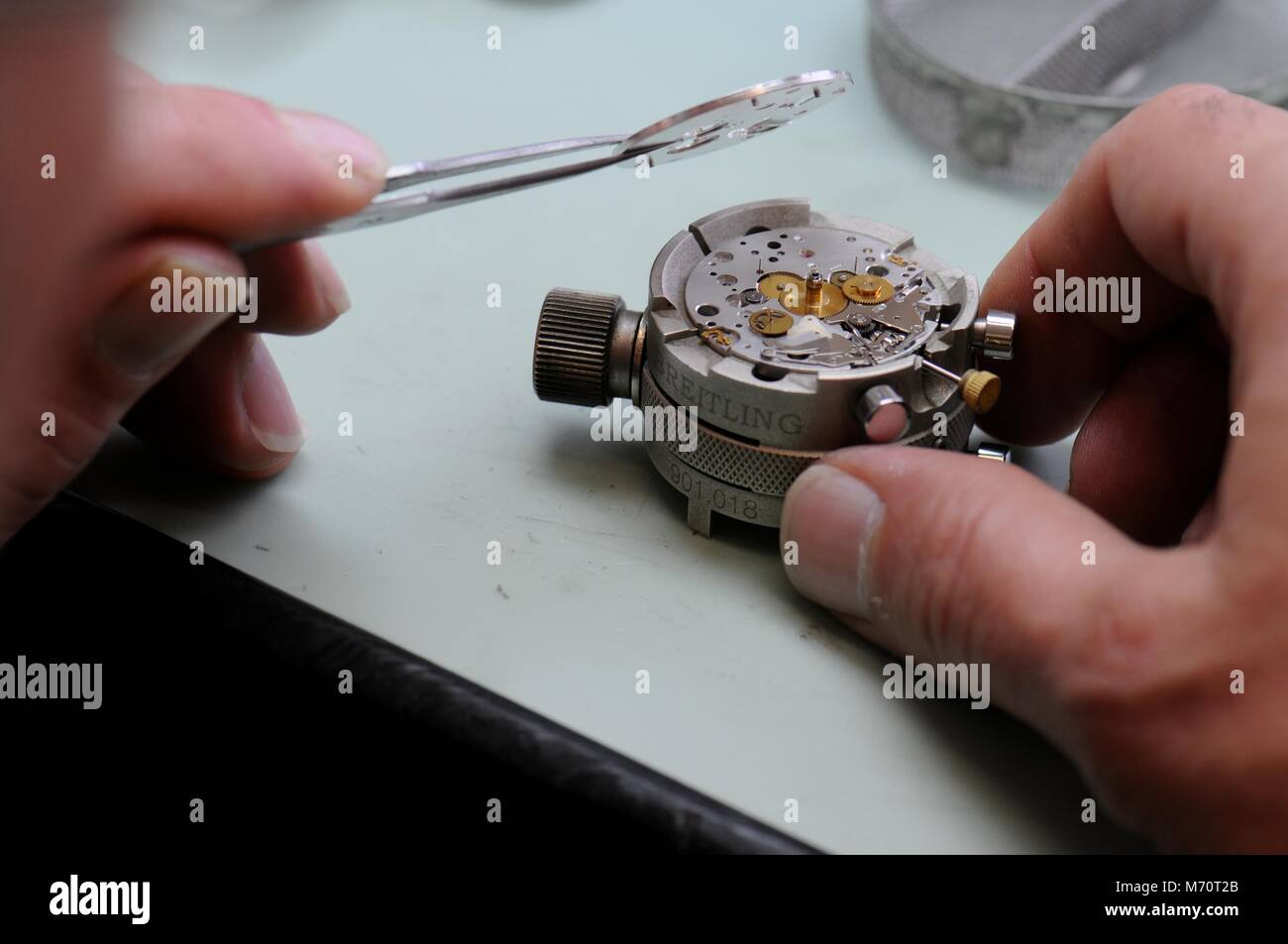 Watchmaker, repair specialist putting watch back together Stock Photo ...