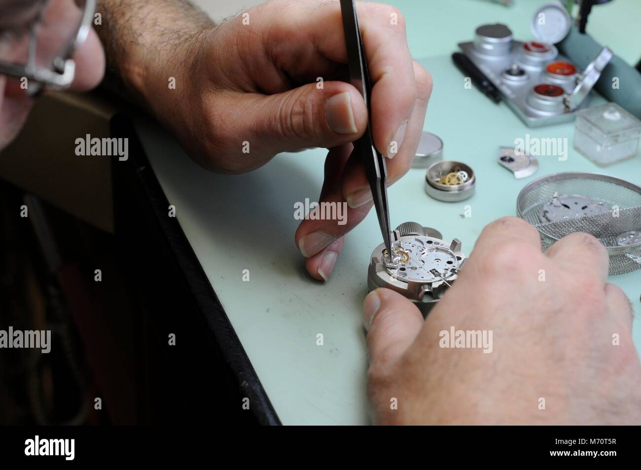 Watchmaker, repair specialist putting watch back together Stock Photo ...