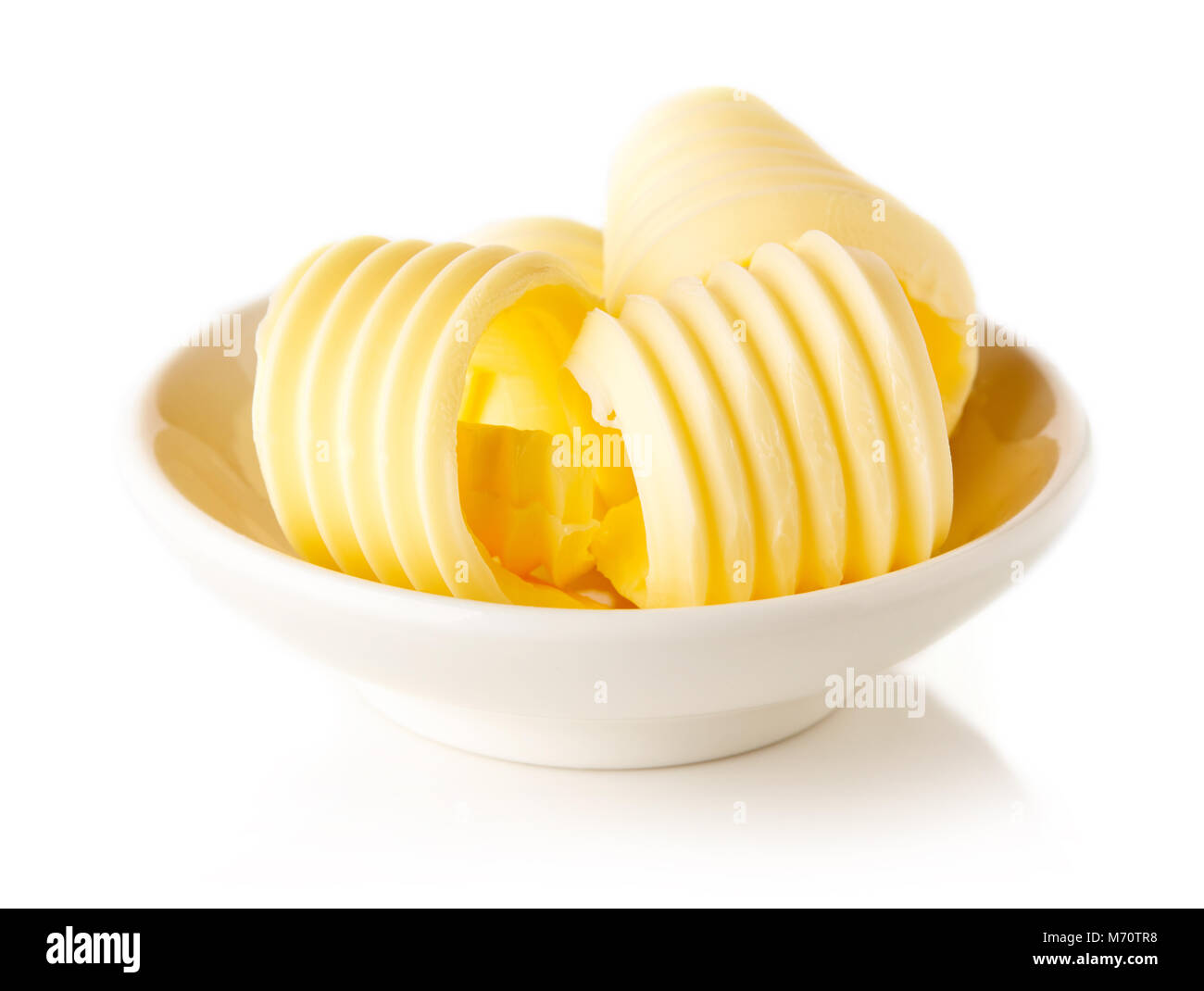 Bowl of butter curls isolated on white background Stock Photo - Alamy