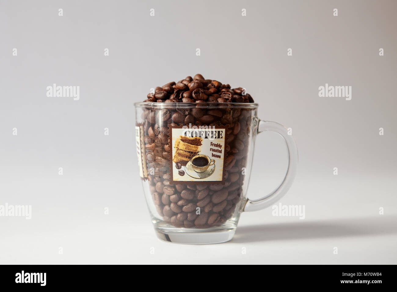 Coffee beans in a see through cup Stock Photo - Alamy