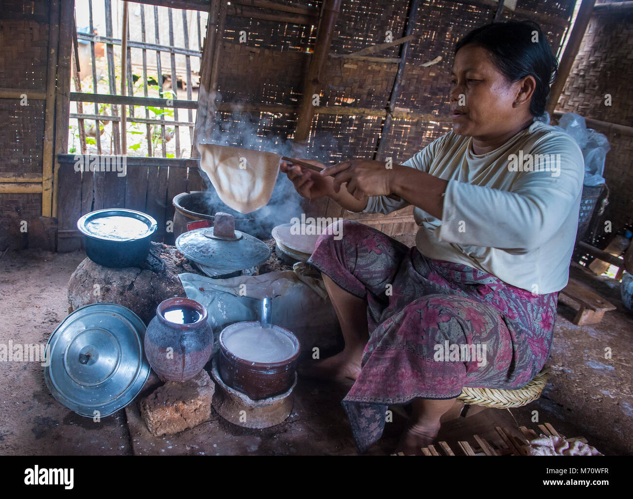 Woman in traditional costume cooking hi-res stock photography and ...