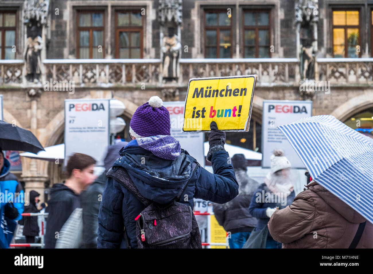 MUNICH / GERMANY - FEBRUARY 15 2018: Lady is raising a sign against the ...