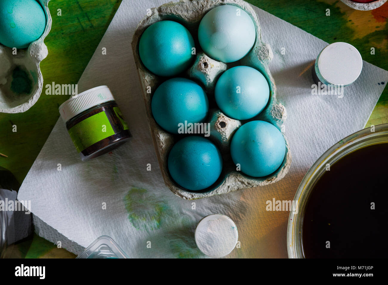 Dyeing eggs for Easter holidays, colored eggs with blue tint and ...