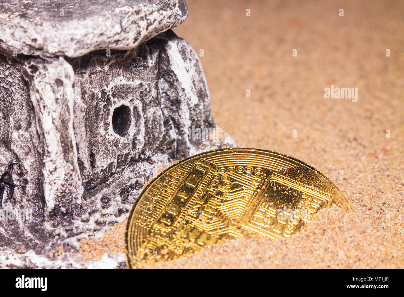 Crypto currency bitcoin in the sand near the ancient temple Stock Photo ...