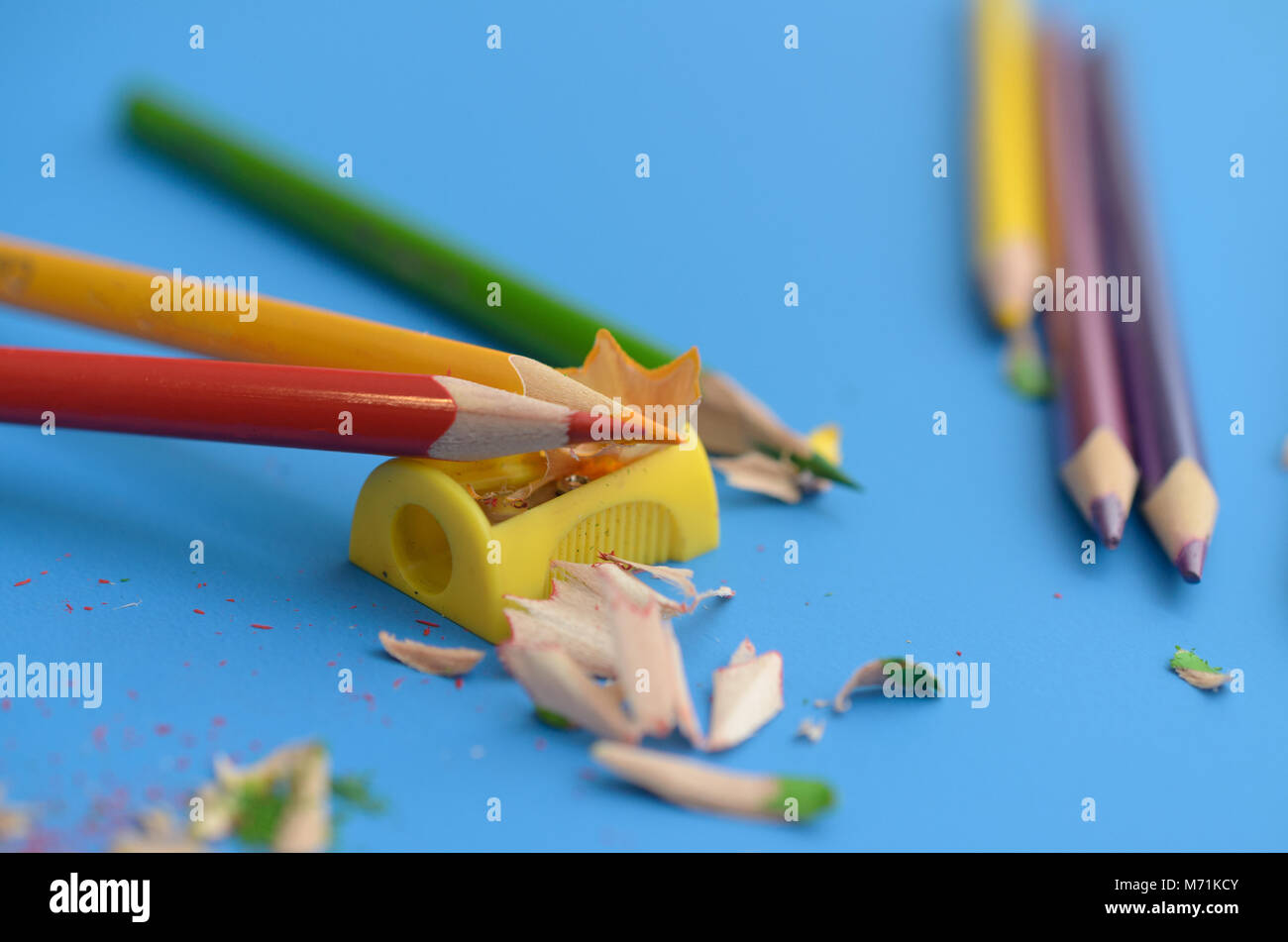 Sharpen the colored pencils with a sharpener Stock Photo - Alamy