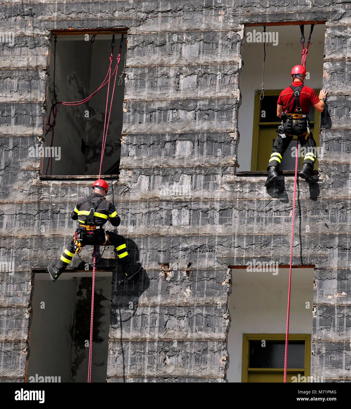 two firefighter climbing a wall of a house during the fire drill Stock ...