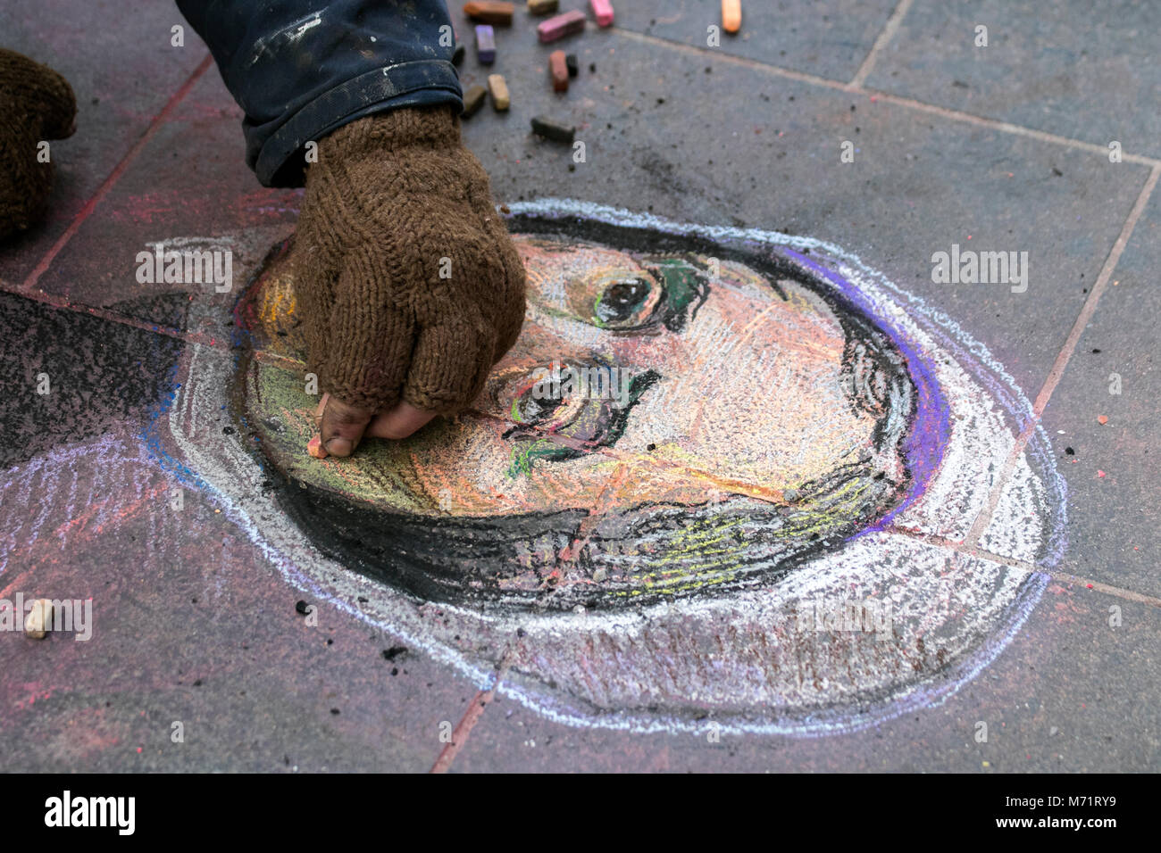 A chalk artist drawing a picture of Kitty Wilkinson on the pavement of ...