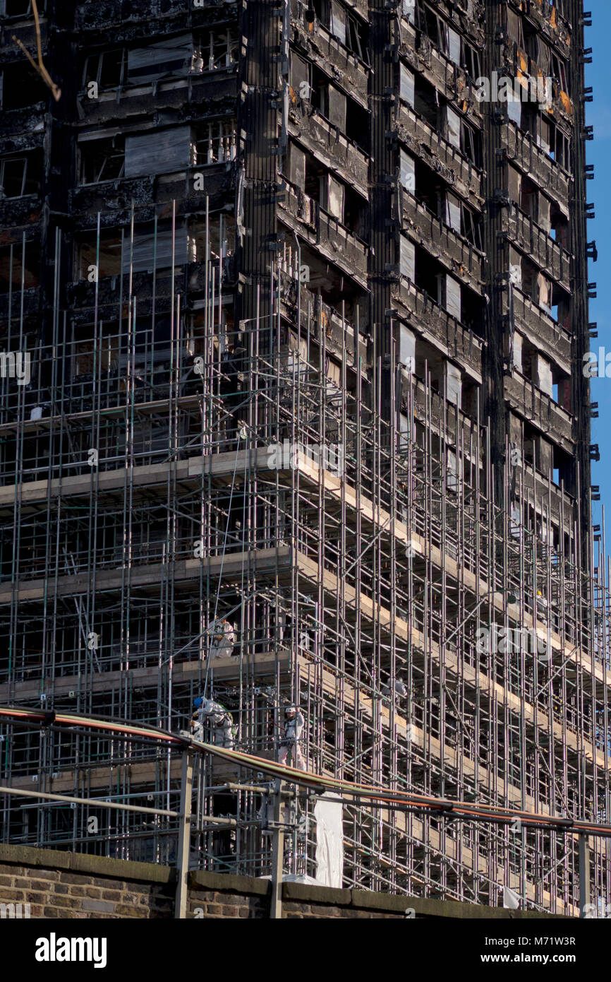 Construction workers building scaffolding before demolition of burnt ...