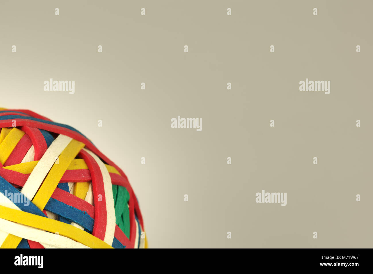 Rubber band ball made from many colourful elastic bands isolated on a ...