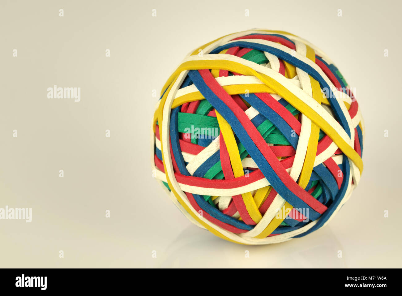 Rubber band ball made from many colourful elastic bands isolated on a ...