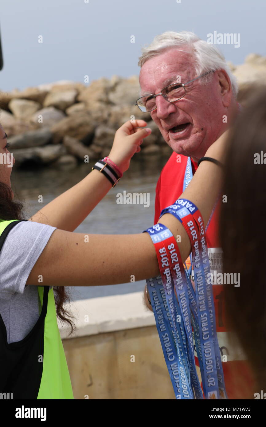 Mature man receiving his medal at the 20th Logicom Cyprus marathon ...