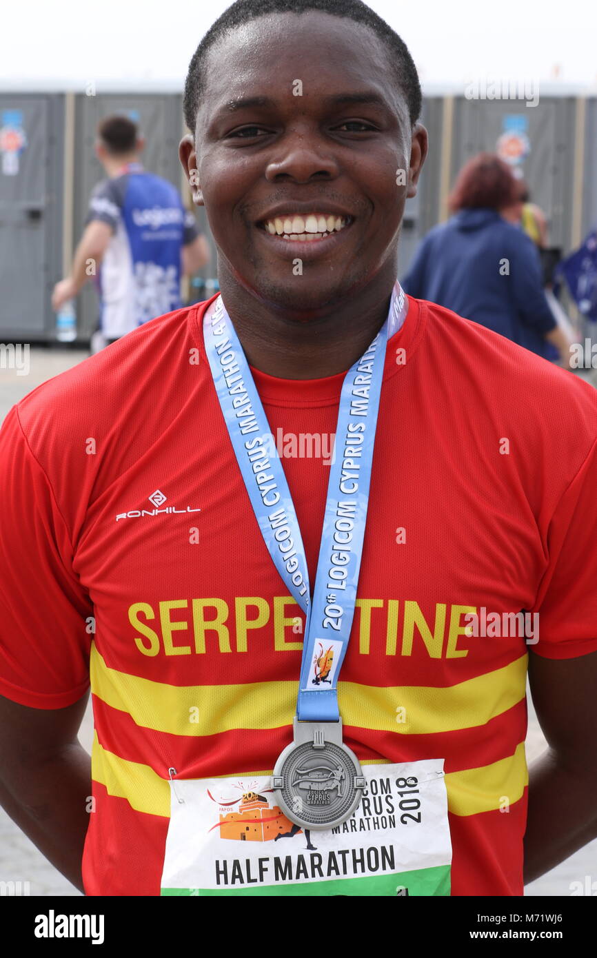 Black man with his medal at the 20th Logicom Cyprus marathon, half ...