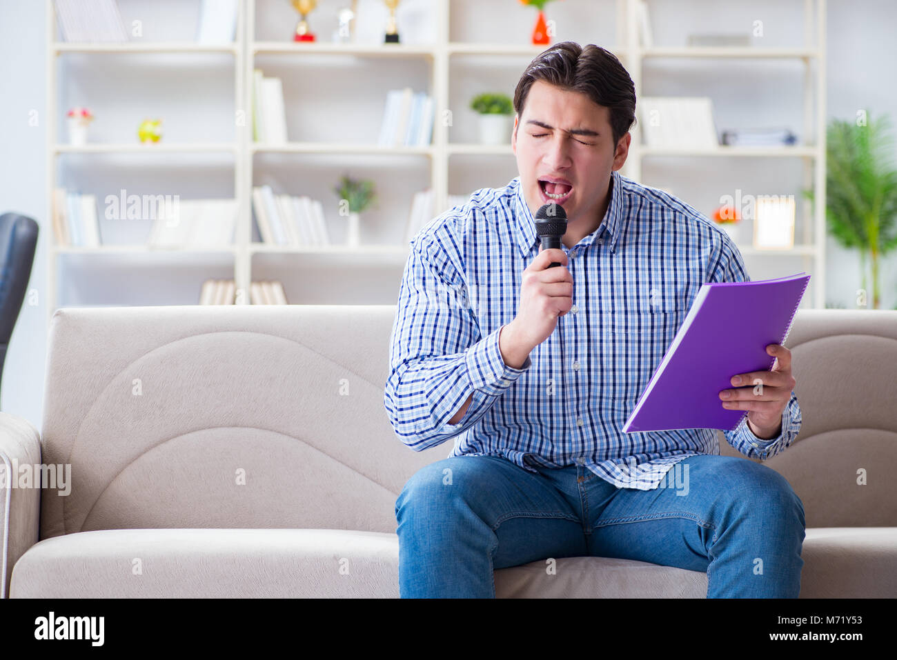Funny man singing songs in karaoke at home Stock Photo - Alamy