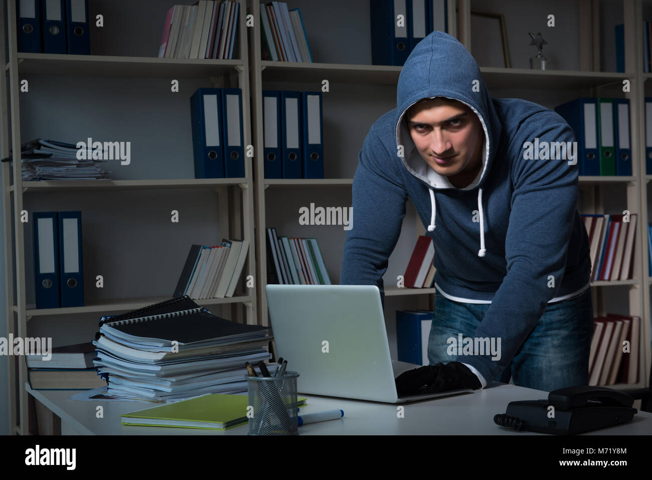 Young hacker hacking into computer at night Stock Photo - Alamy