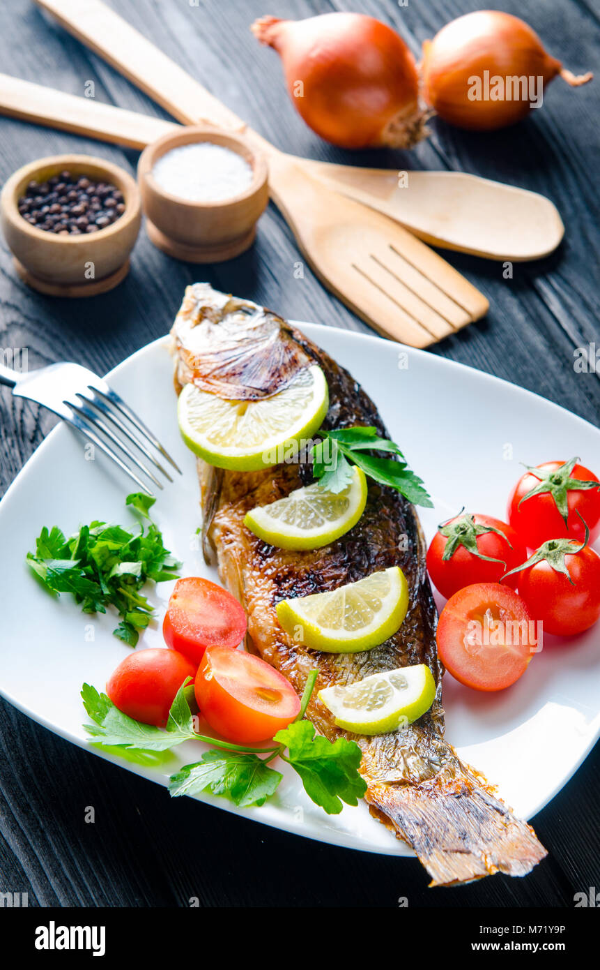Fried fish served on the plate Stock Photo - Alamy
