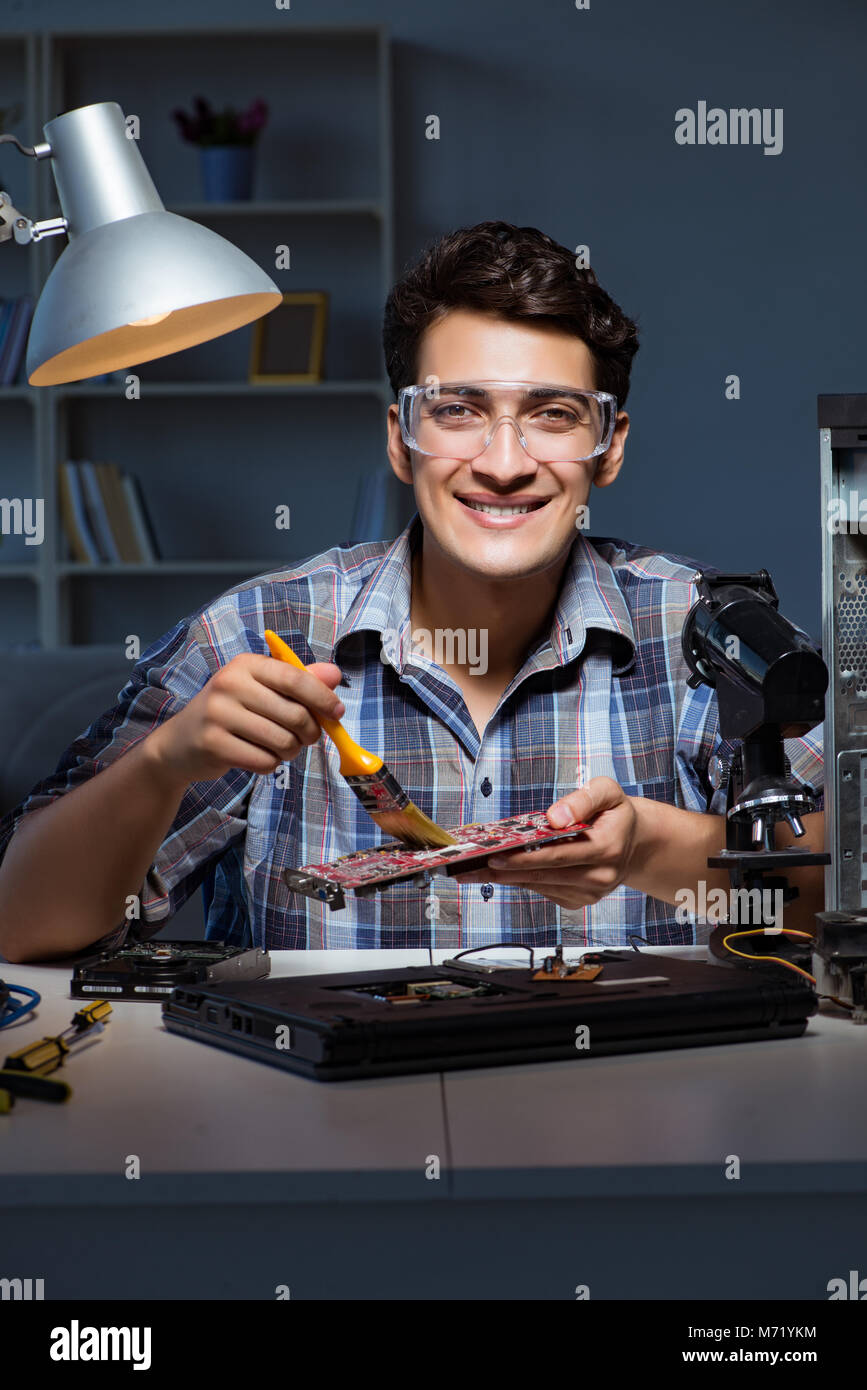 Computer repair man cleaning dust with brush Stock Photo - Alamy